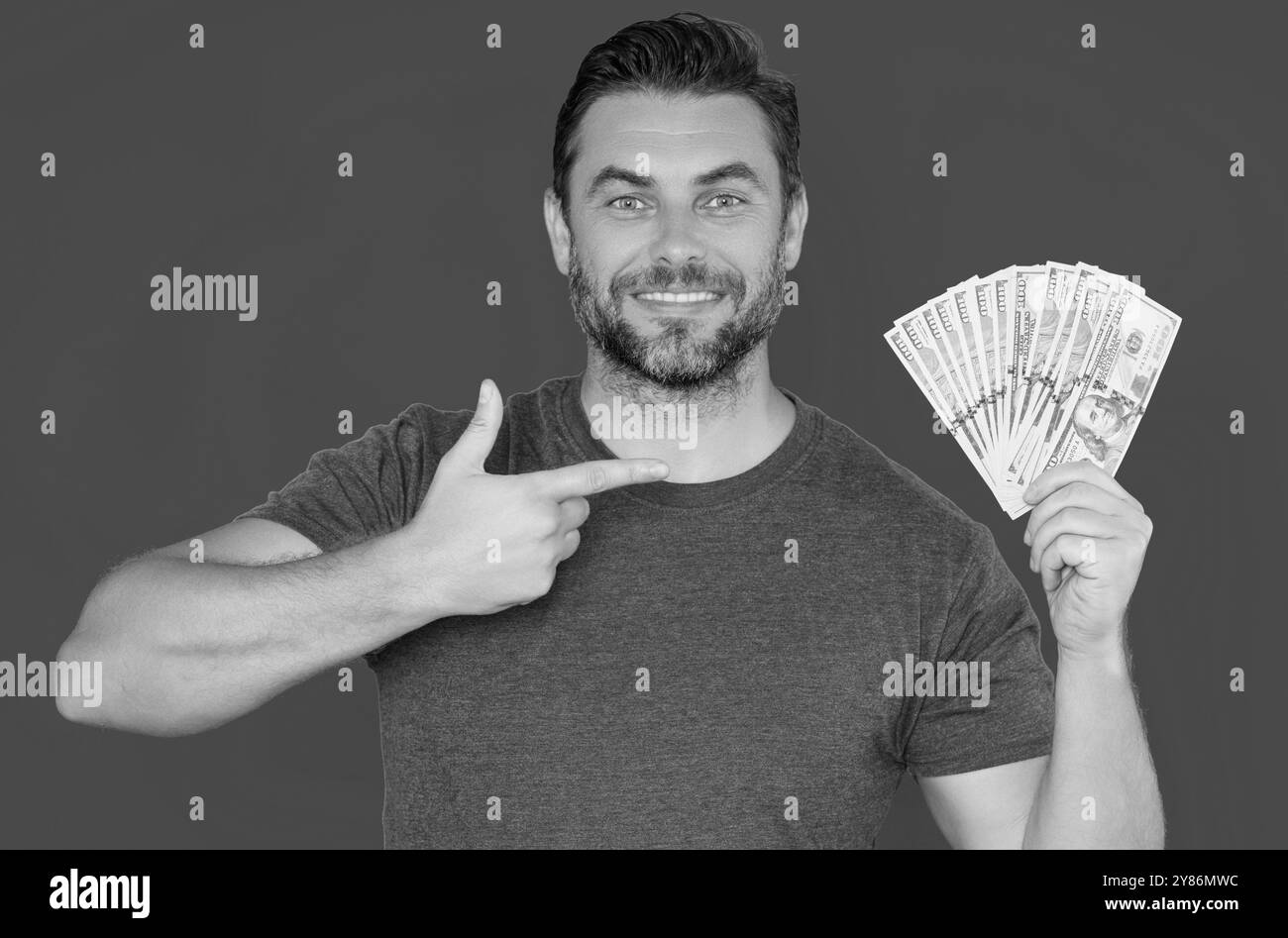 Money cash, dollar banknotes concept. Portrait of man holding bunch of ...