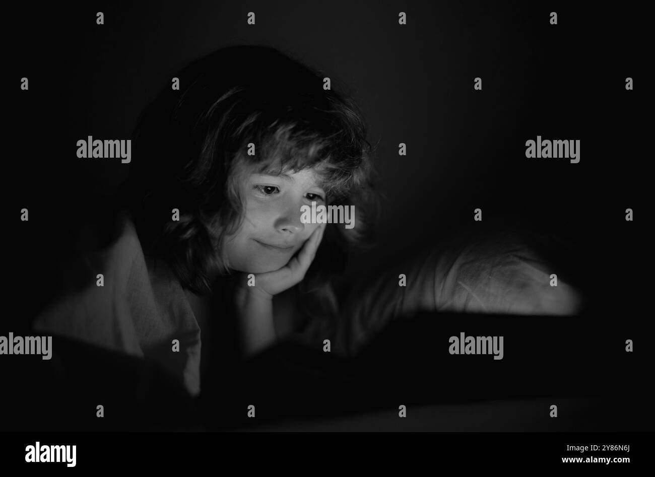 Kid is addicted to tablet, kid use tablet, watching cartoon. Child watching his tablet in the ...