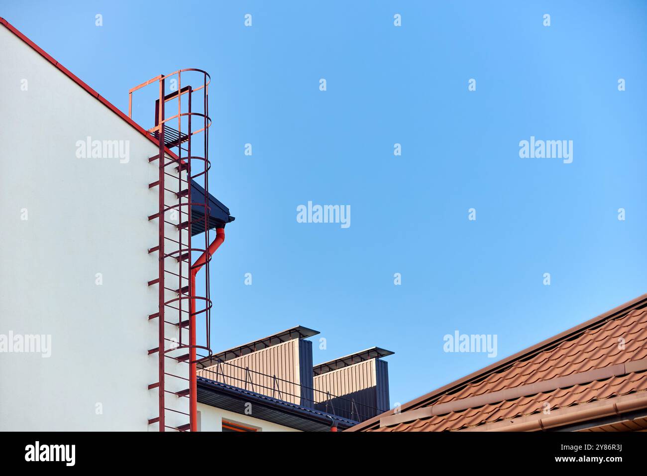 Secure stairs to the roof of the building. Metal. Red. Industrial ...