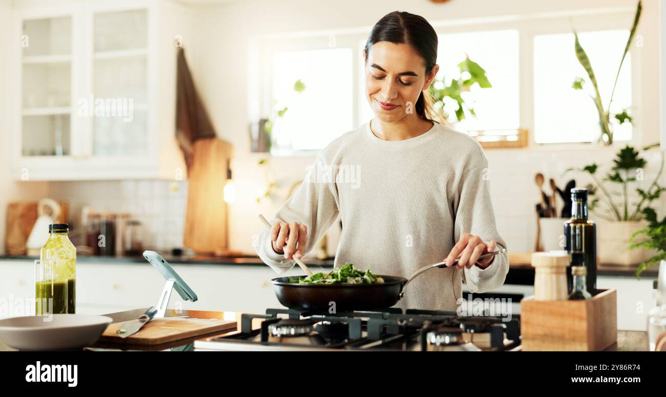 Cooking, woman and kitchen with pan, healthy food and relax in home ...