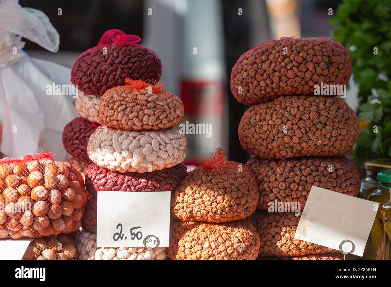 Various traditional snacks are stacked for sale at a bustling outdoor ...