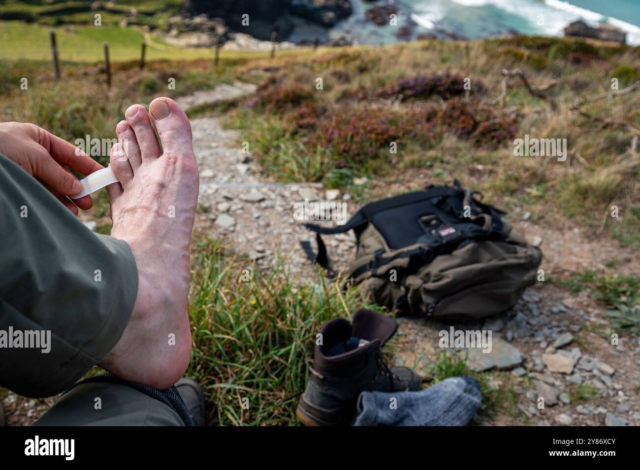 Blisters prevention while hiking. A hiker on the south west coast path ...