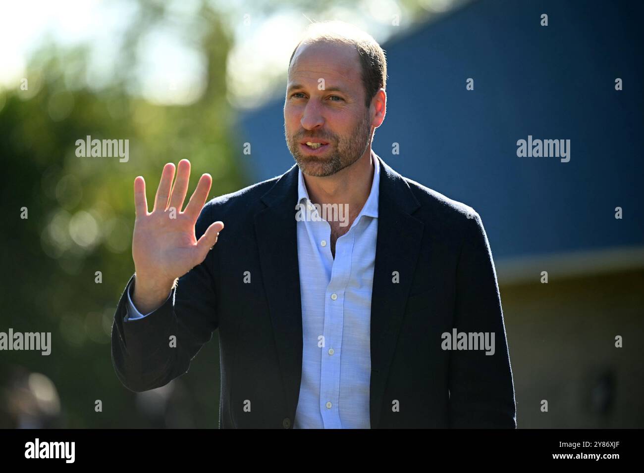 The Prince of Wales waves upon his arrival to visit Birtley Community ...