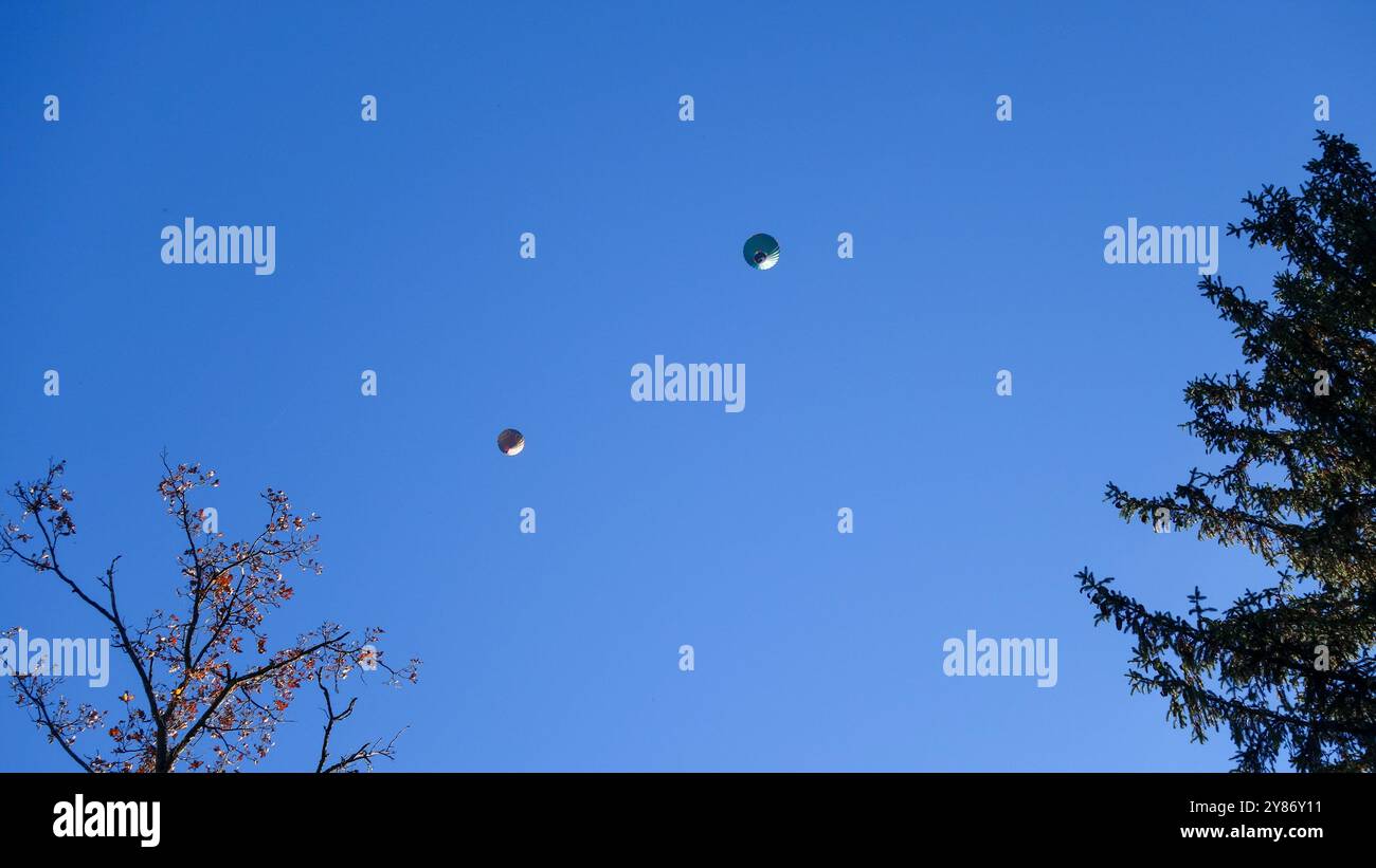Two hot air balloons from above in a clear blue sky Stock Photo - Alamy