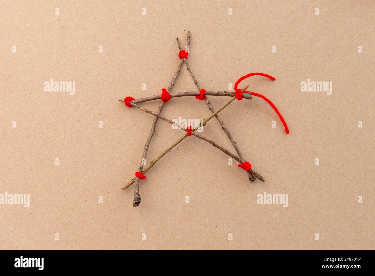 Step-by-step tutorial on making a star-shaped ornament from sticks and ...