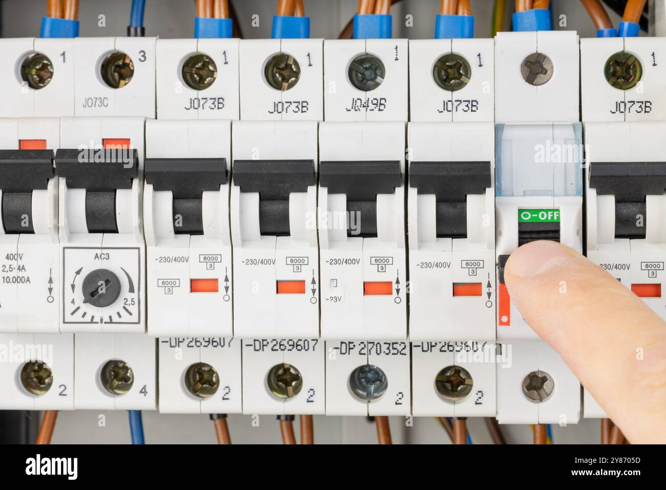 Finger pressing circuit breaker in electrical control panel Stock Photo ...