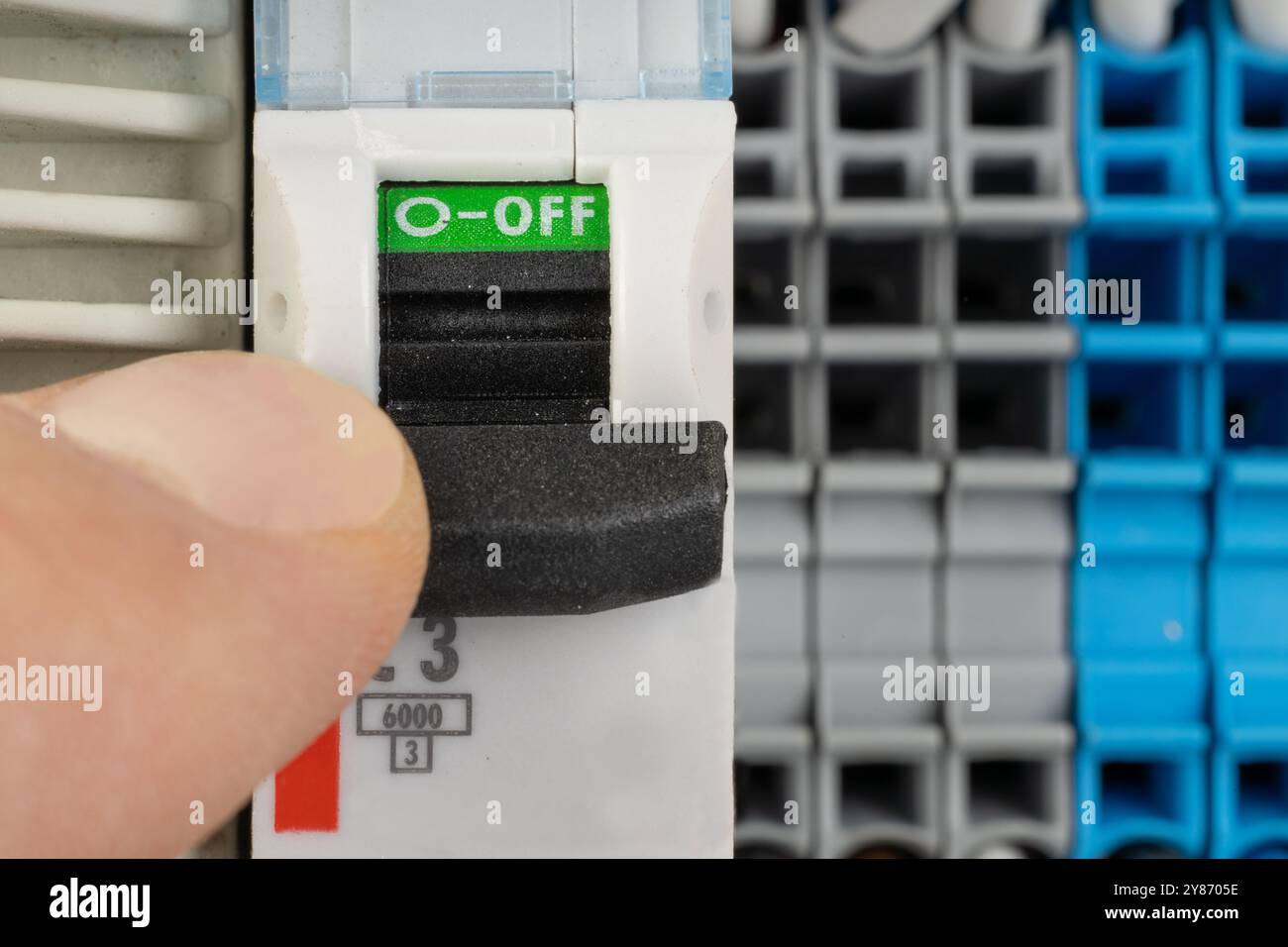 Hand switching off electrical circuit breaker in panel Stock Photo - Alamy