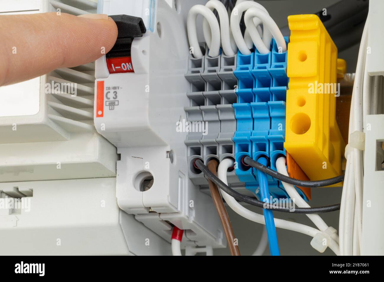 Hand turning on electrical circuit breaker in panel Stock Photo - Alamy