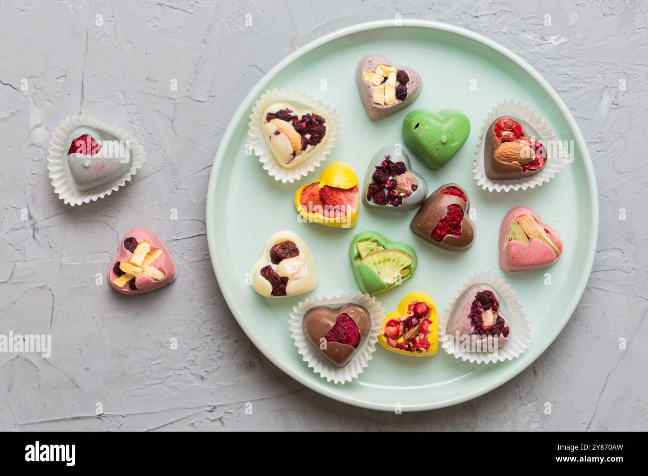 Plate with different chocolate on colored background. Assortment of ...