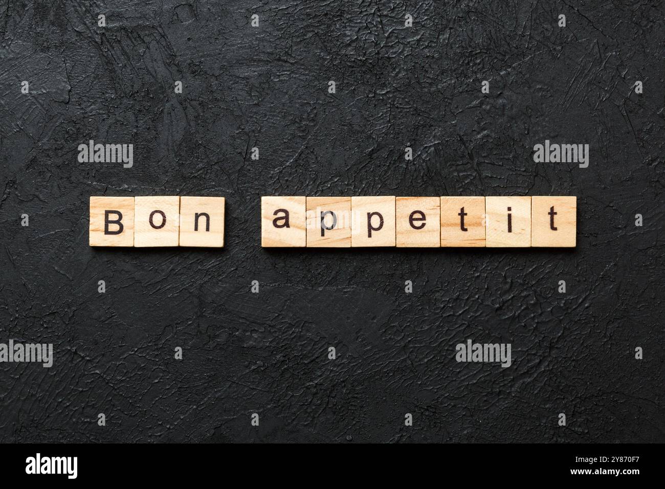 Bon Appetit word written on wood block. Bon Appetit text on cement ...