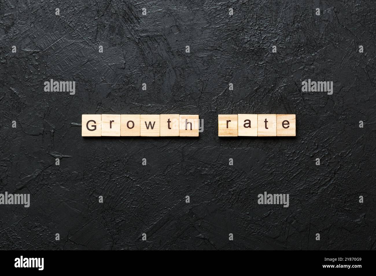 growth rate word written on wood block. growth rate text on cement ...