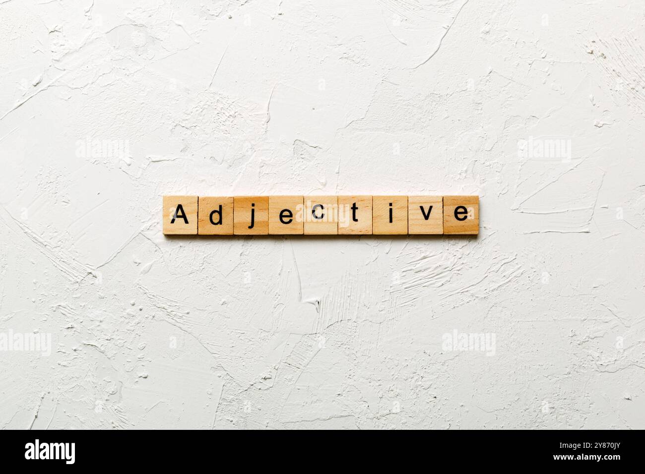 adjective word written on wood block. adjective text on cement table ...