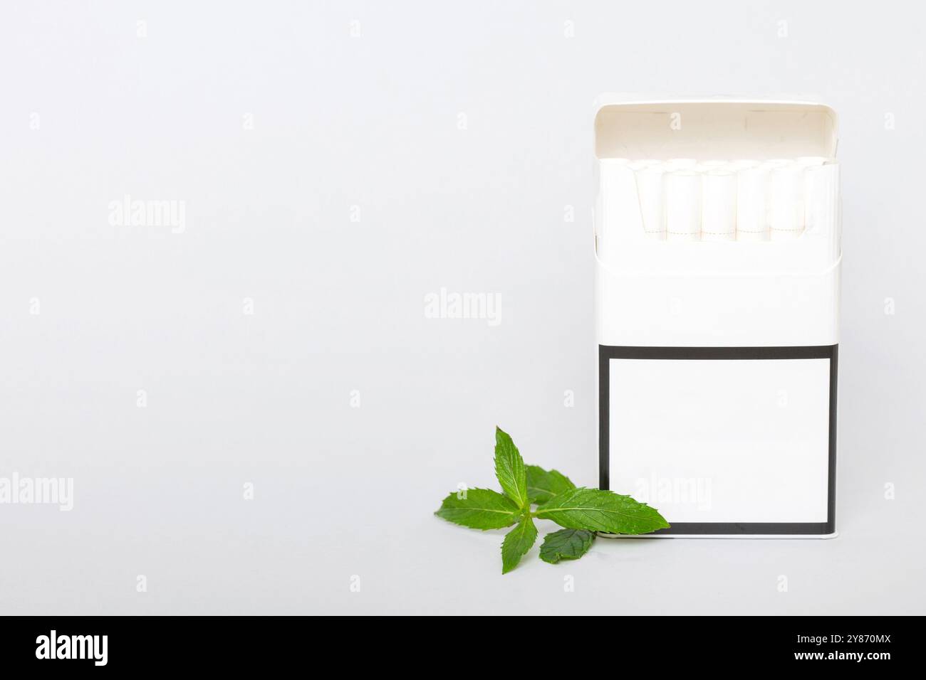 Pack of menthol cigarettes and fresh mint on colored table, Menthol ...