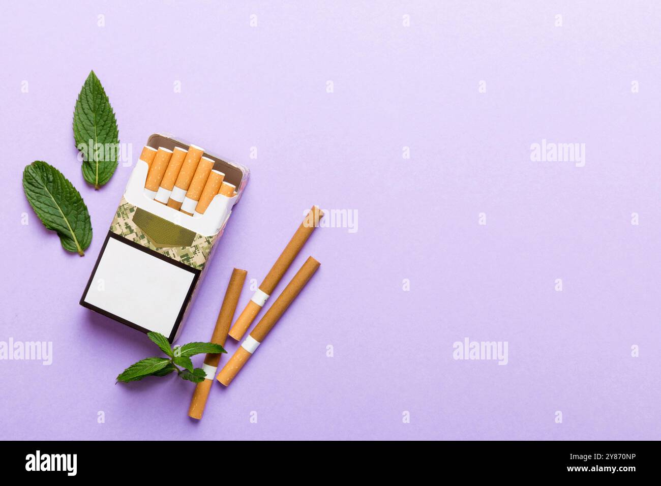 Pack of menthol cigarettes and fresh mint on colored table, Menthol ...