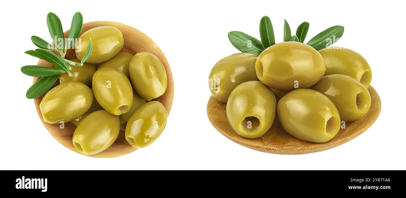 Green olives with leaves in wooden bowl isolated on a white background ...