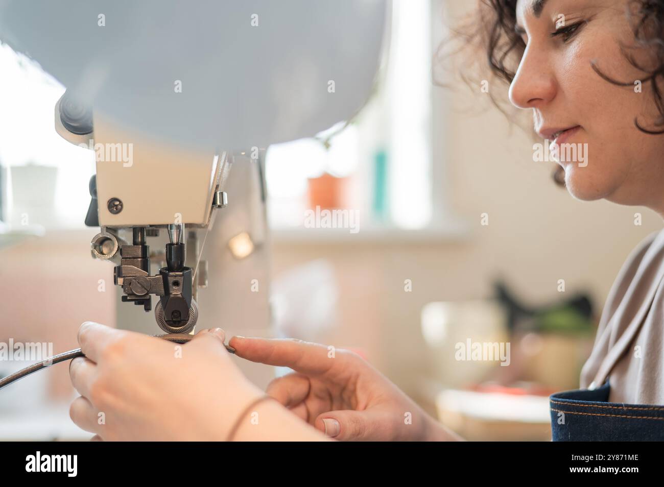 Woman tanner sews leather hi-res stock photography and images - Alamy