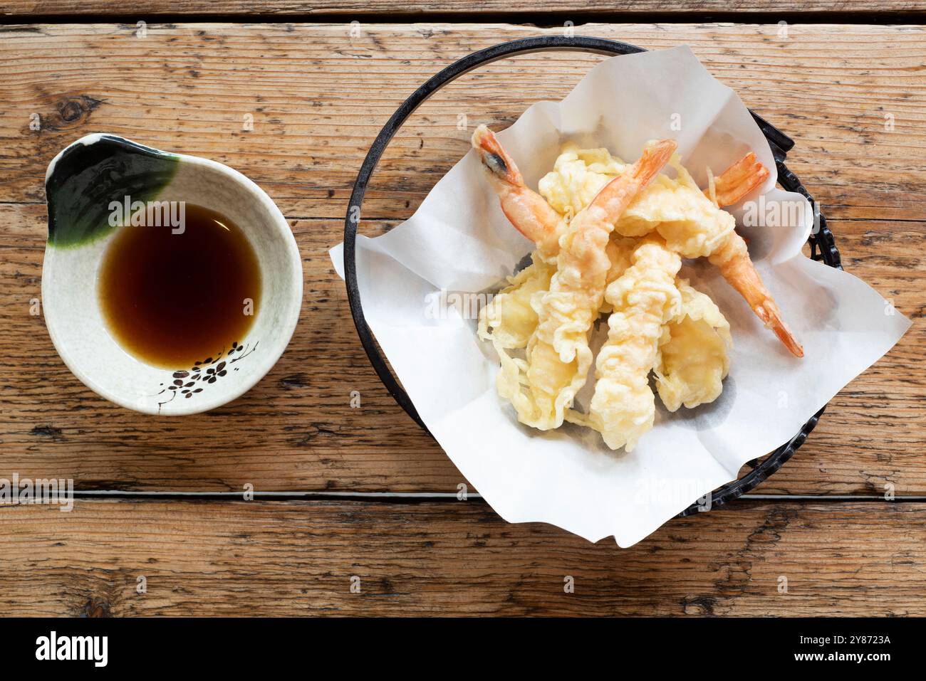 Chinese tempura battered king prawns served in a basket with a soy ...