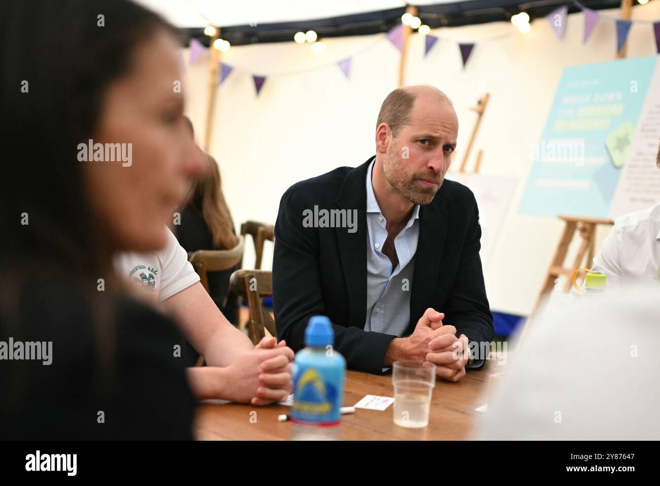 The Prince of Wales takes part in a round table discussion during a ...