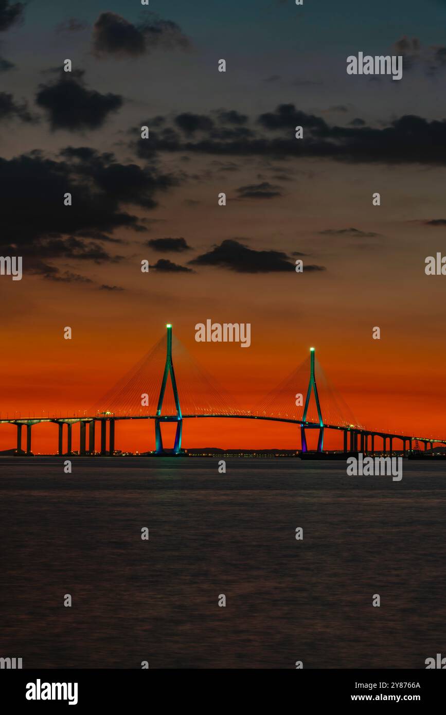 A dusk view of Incheon Bridge, illuminated with blue lights reflecting ...