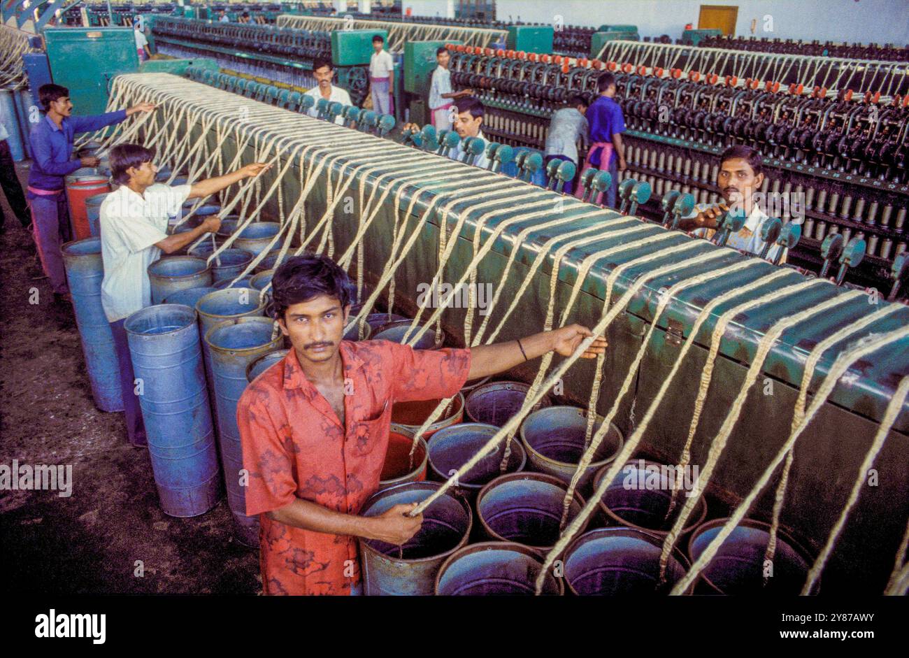 Bangladesh, Dhaka, workers at the spinning mill of a textiles factory ...