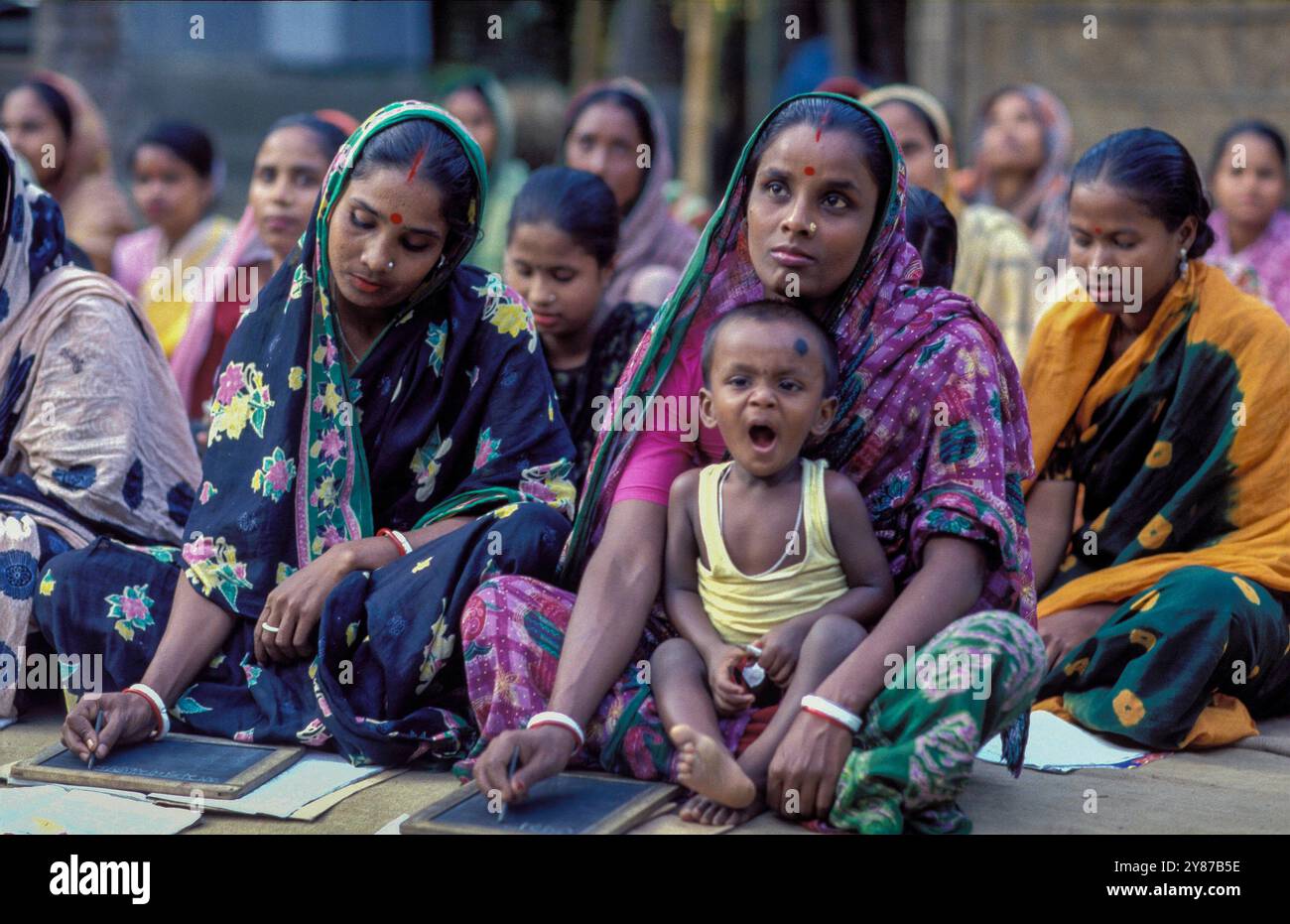 Bangladesh, Dhaka, mother with baby having adult education class Stock Photo - Alamy