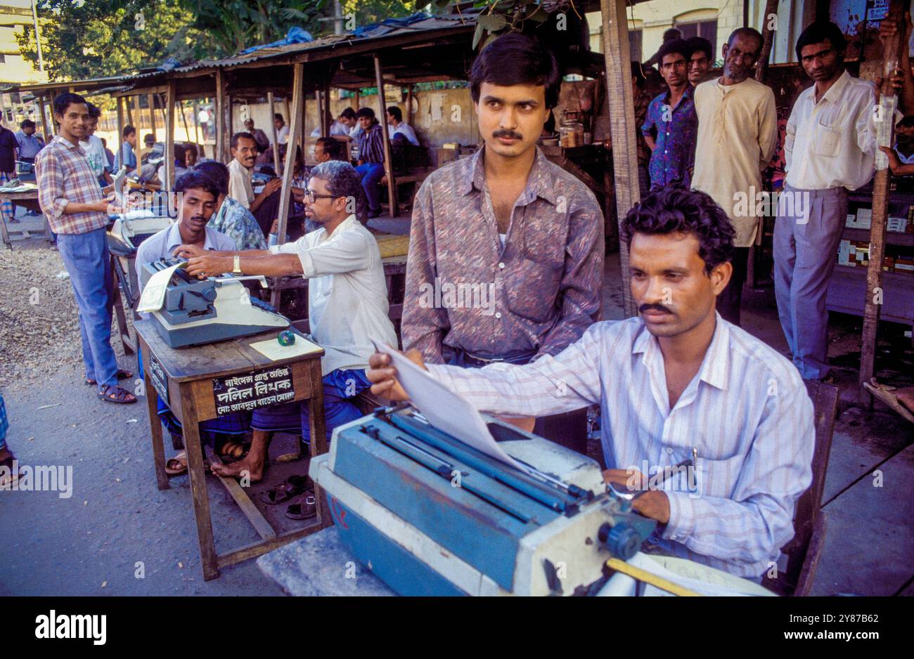 Bangladesh, Dhaka, writers with typewriters fill out forms and/or write ...