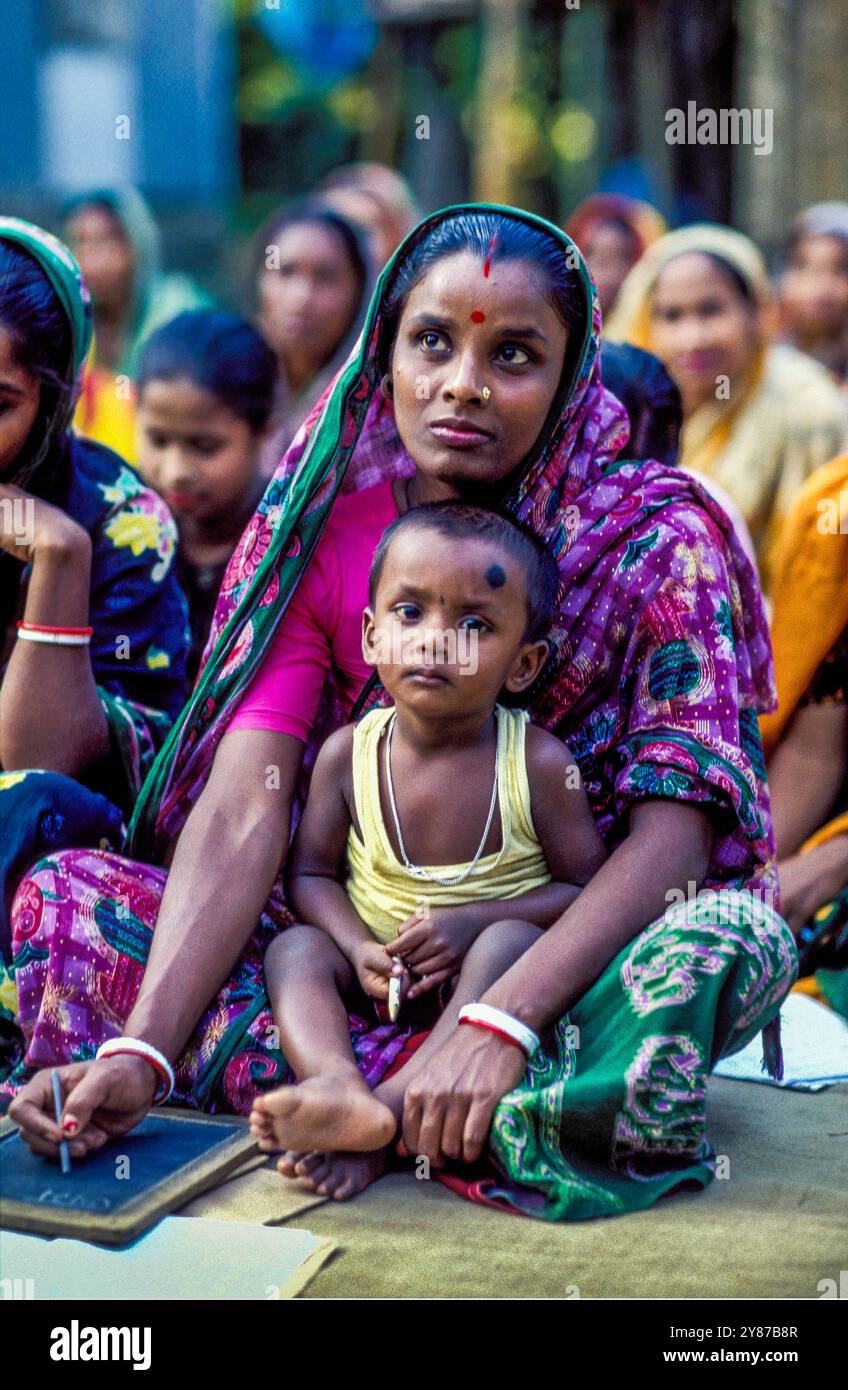 Bangladesh, Dhaka, mother with baby having adult education class Stock Photo - Alamy