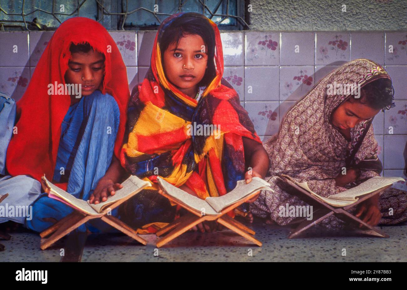 Bangladesh, Dhaka Muslim children of a Madrasa (Islamic religious school) recite the holy Koran ...
