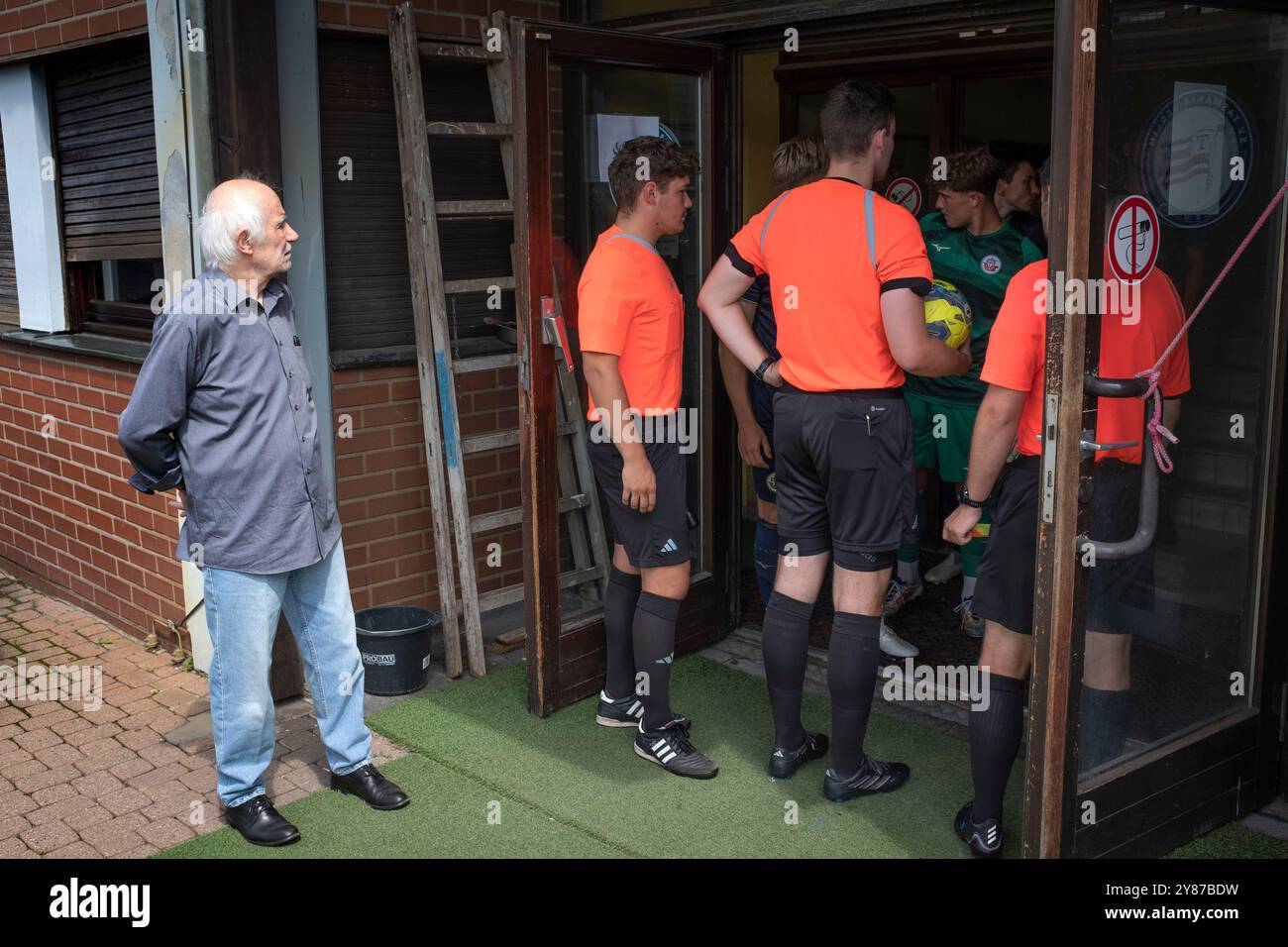 The referee and his assistants waiting for the players outside the ...