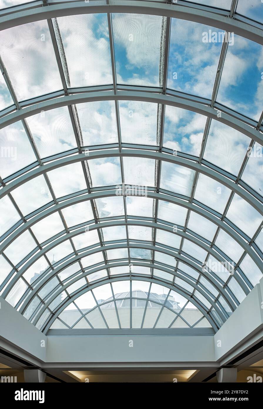 Glass ceiling in blue sky sunlight, abstract. Glass roof of the ...