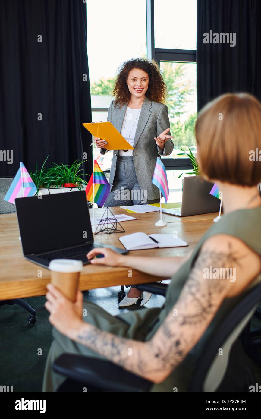 Coworkers celebrate diversity with flags while discussing important ...
