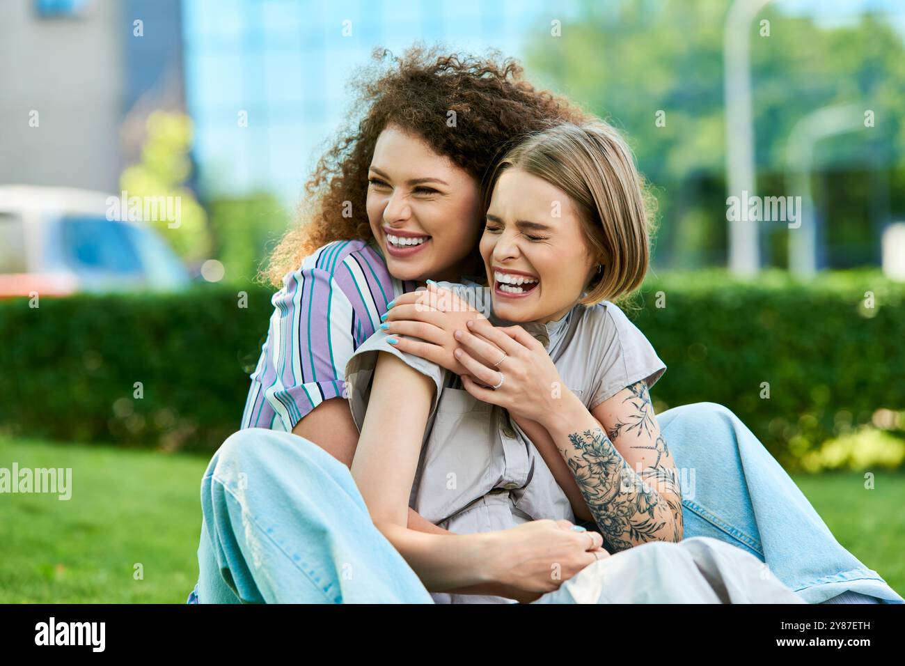 Enjoying a playful moment, two friends embrace each other while ...