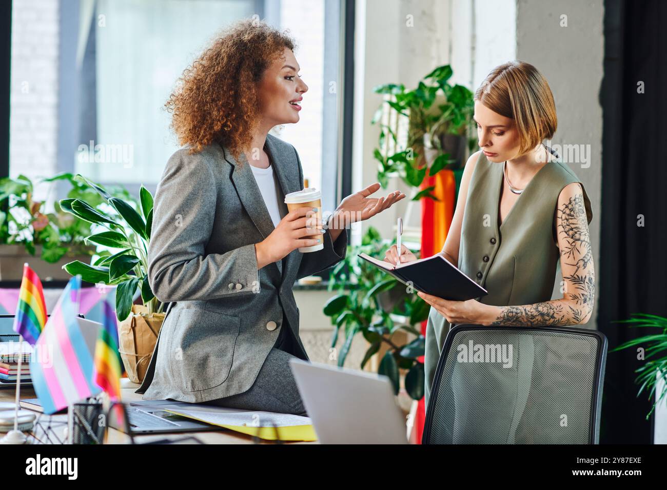 Two colleagues share ideas and collaborate in a vibrant office ...