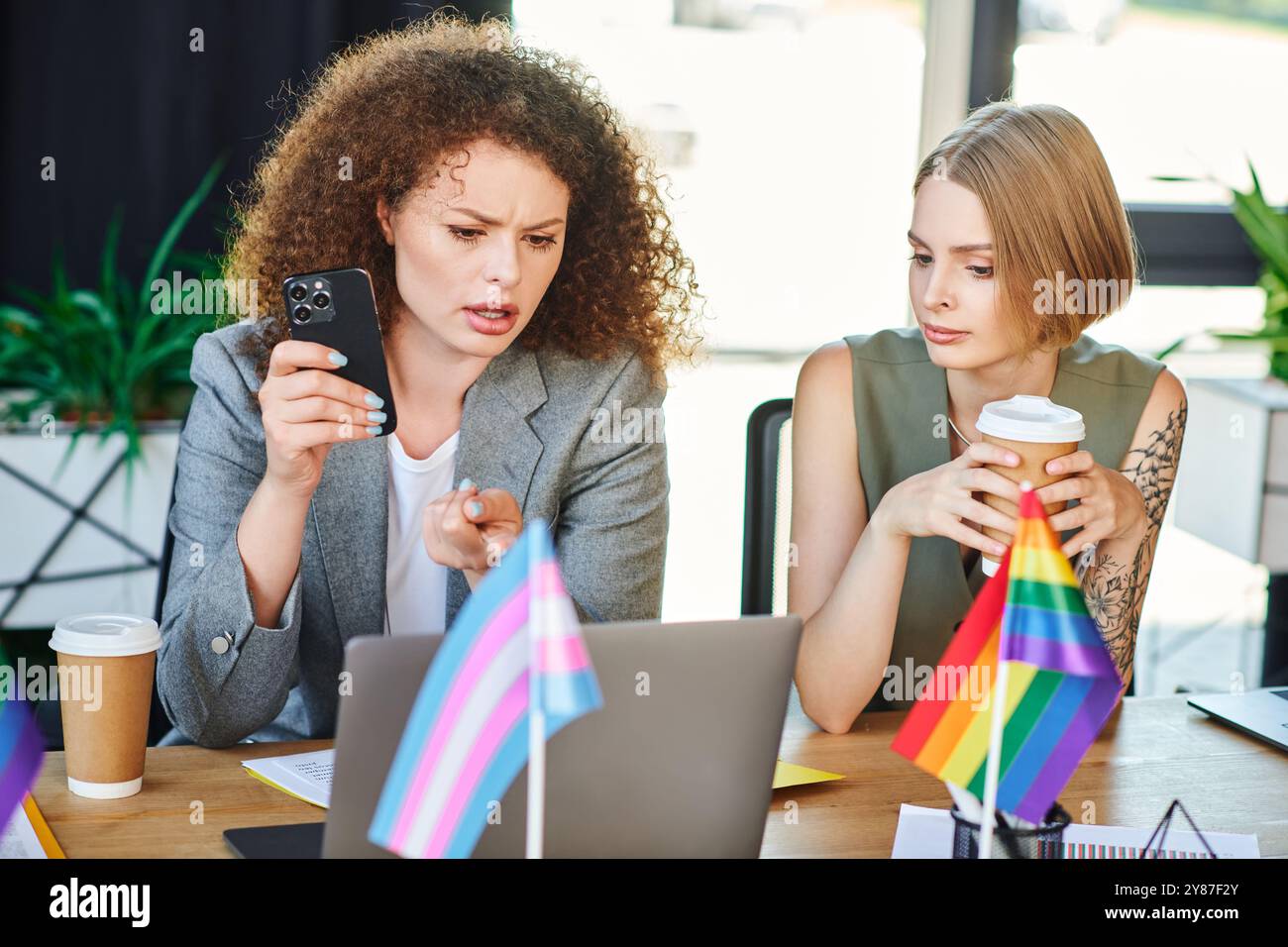 Two coworkers share a passionate conversation over coffee in a lively ...