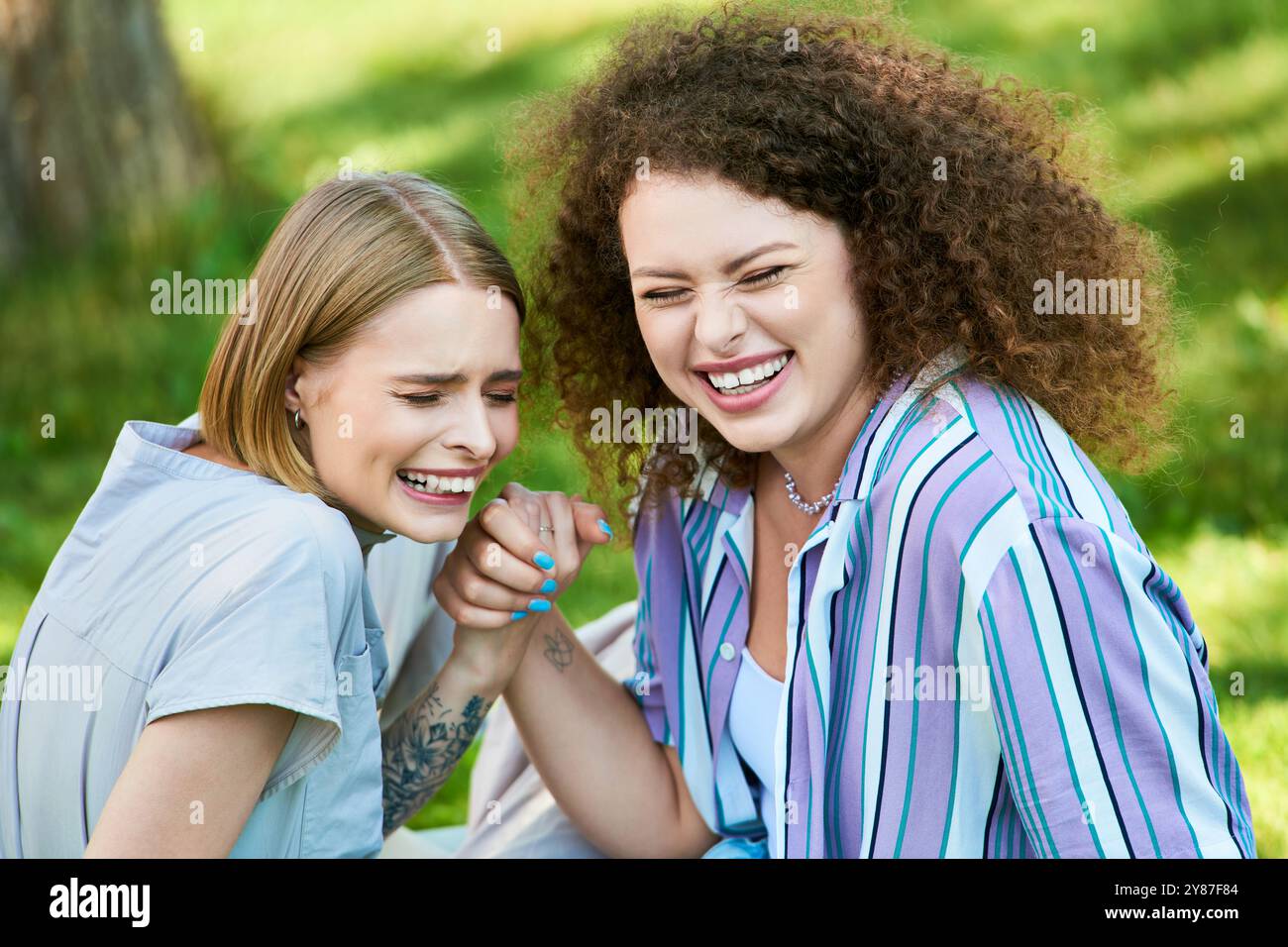 Two friends share joyous moments, laughing together while embracing ...