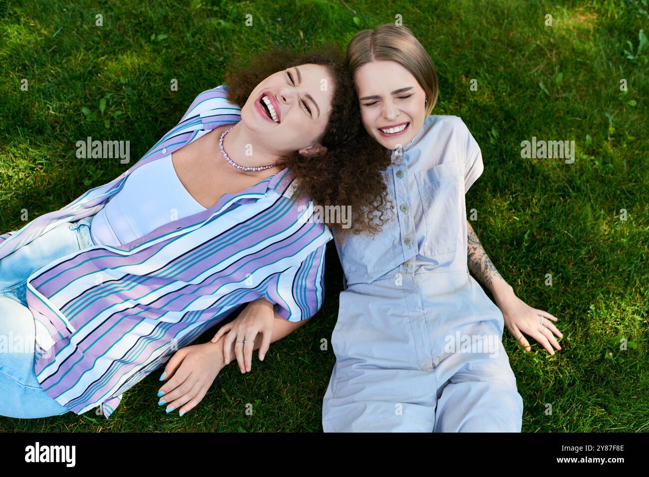 Two young women enjoy each others company, laughing together while ...