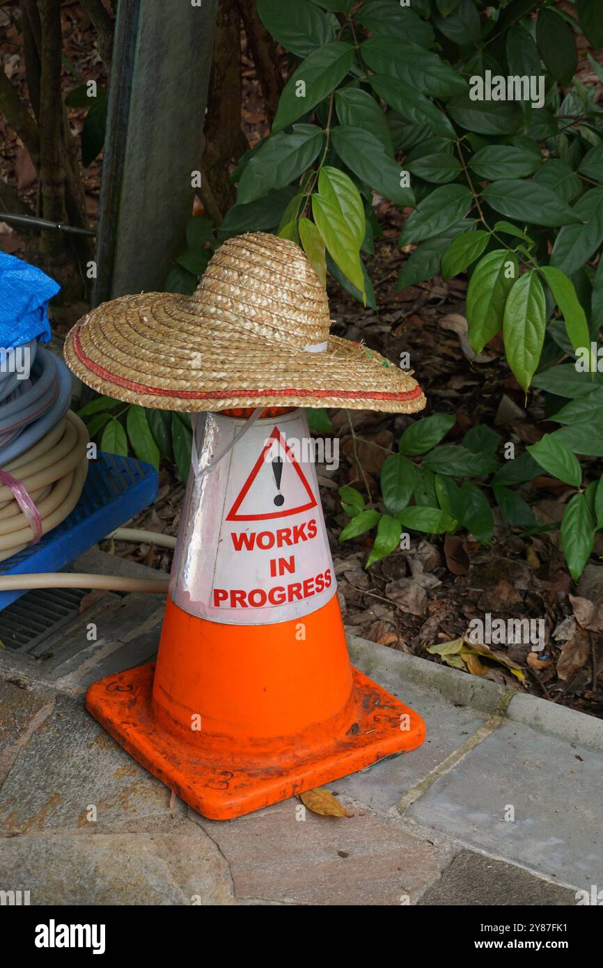 strawhat on work in progress sign - pause or progress Stock Photo - Alamy