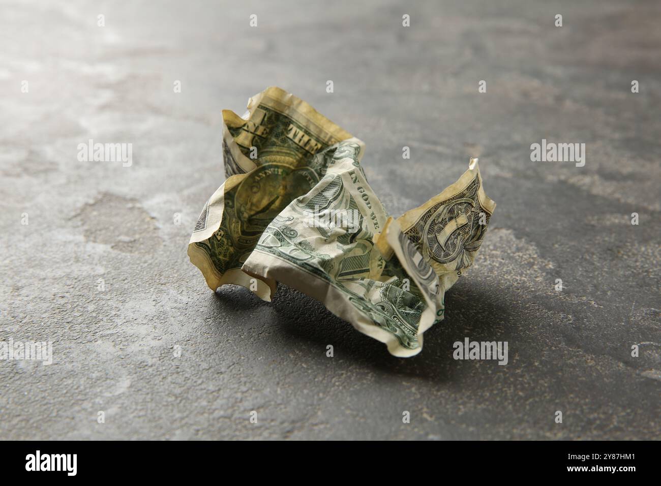 One crumpled dollar banknote on grey table, closeup Stock Photo - Alamy