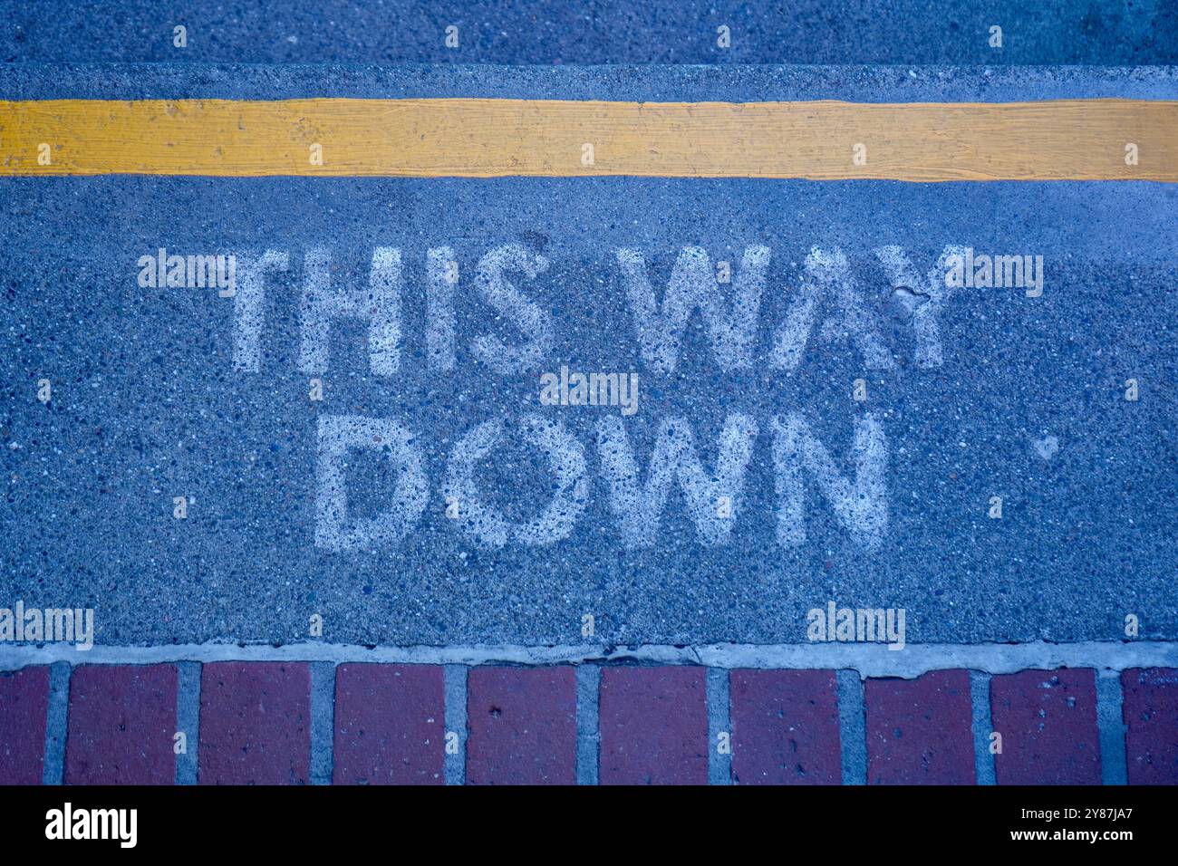 This Way Down painted on a step with a yellow line above Stock Photo ...