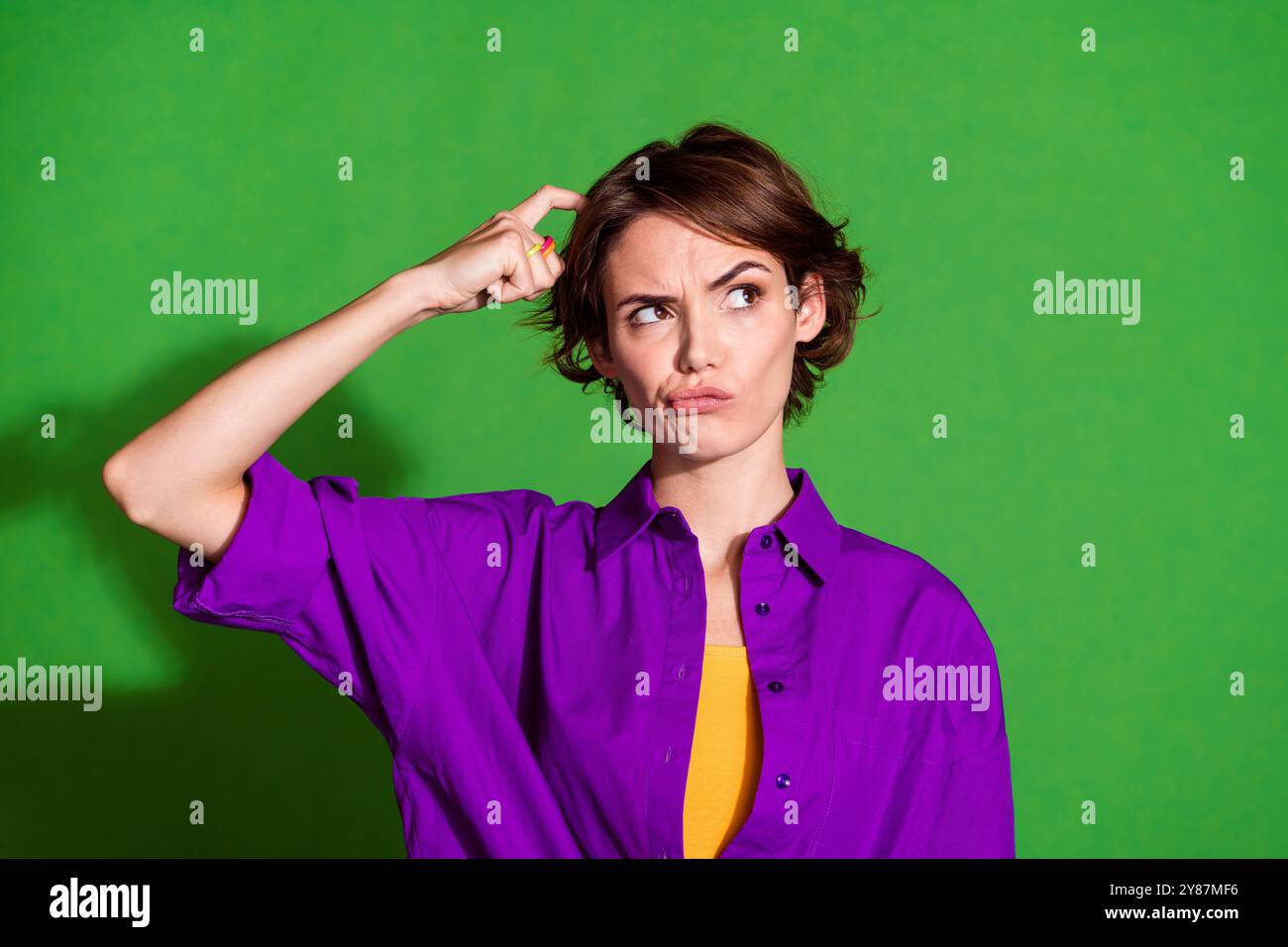 Portrait photo of young lady guessing when scratching head in purple ...