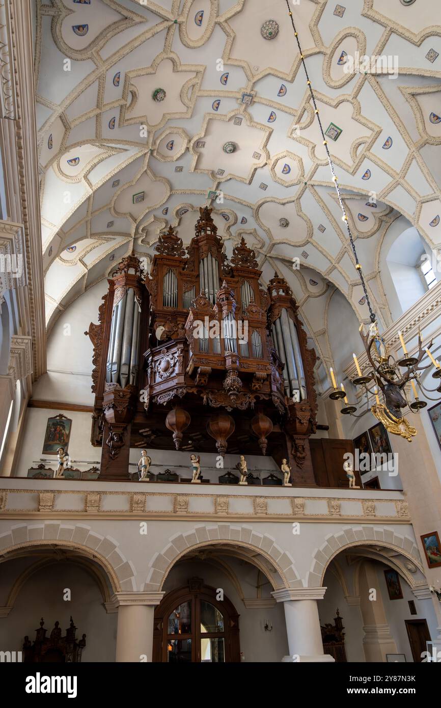 Admire the grandeur of a Baroque pipe organ with intricate wood ...