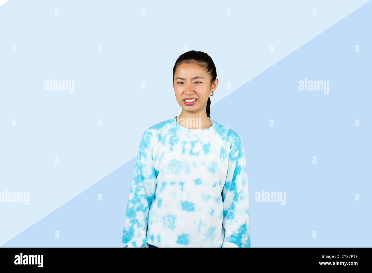 Young Asian Girl in blue dress disgust happy expression and face ...
