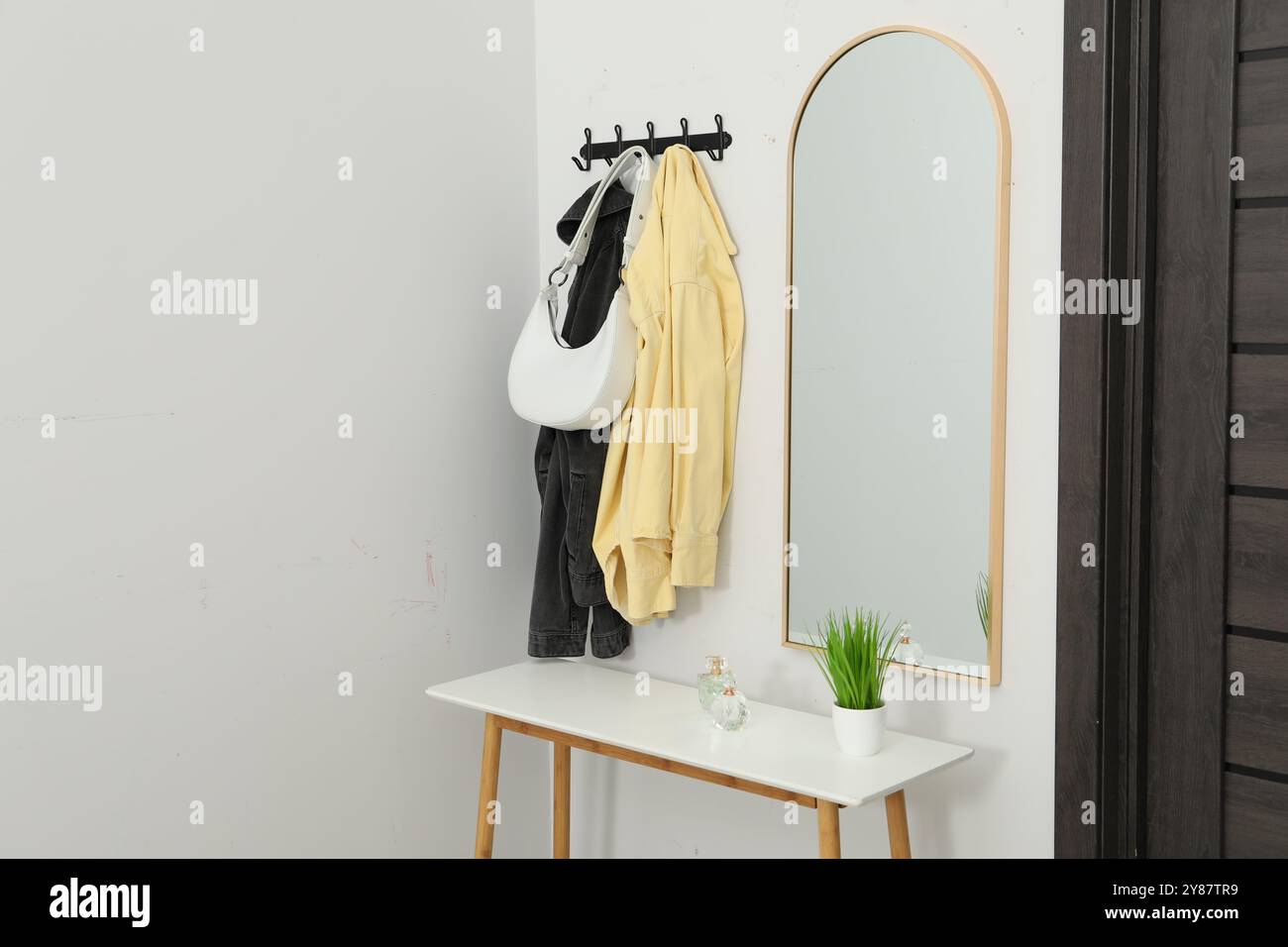 Mirror, rack with clothes and shoe storage bench in hallway. Interior ...