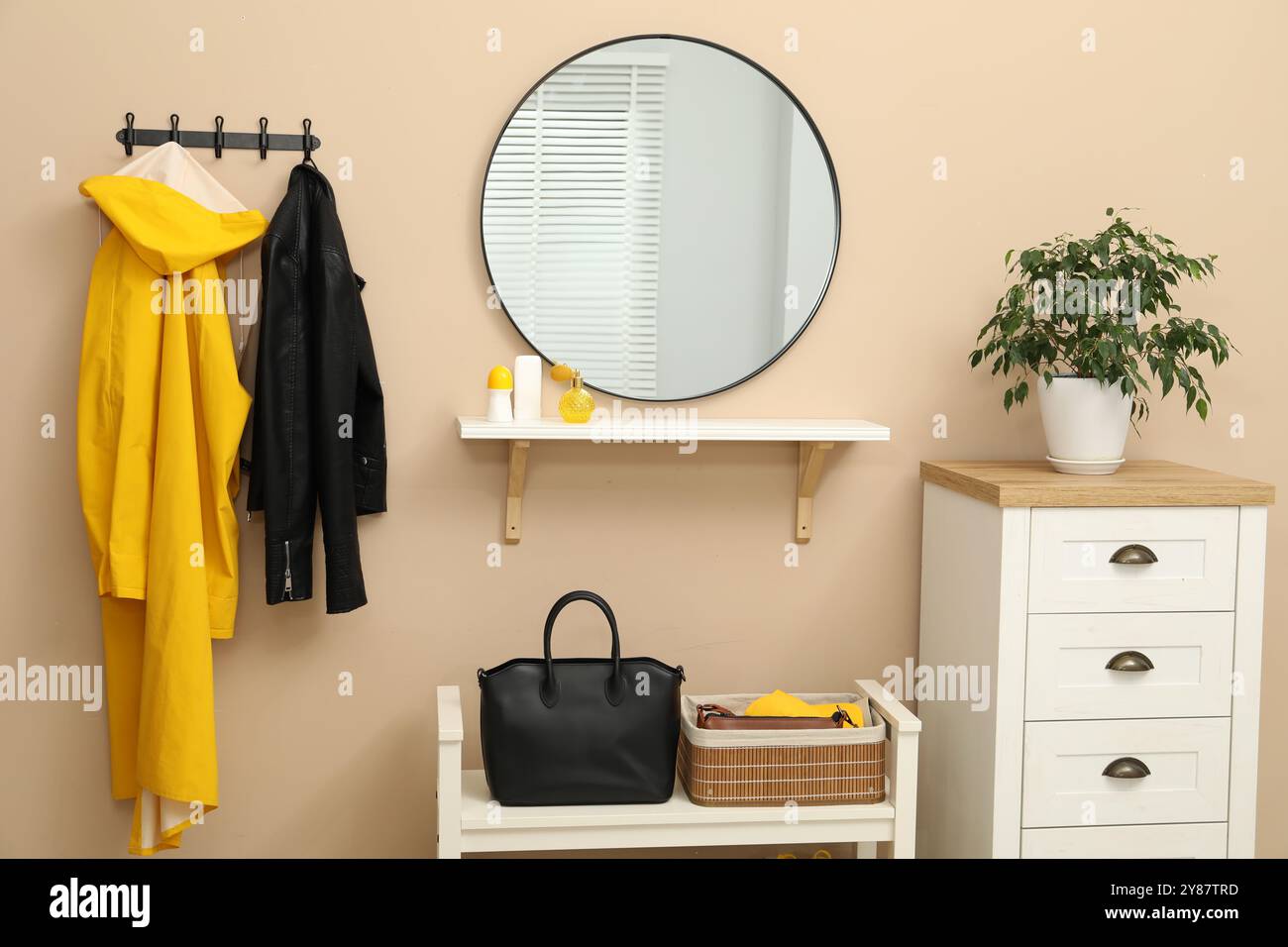 Coat rack with clothes, mirror, shoe storage bench and chest of drawers ...