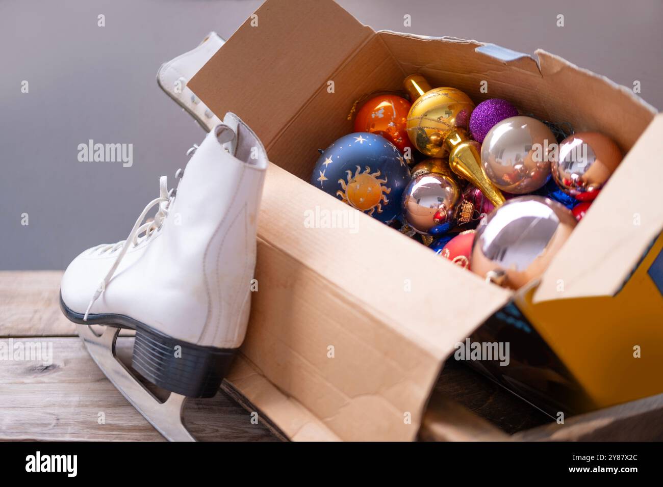 rustic storage solution white ice skates and cardboard box filled with ...