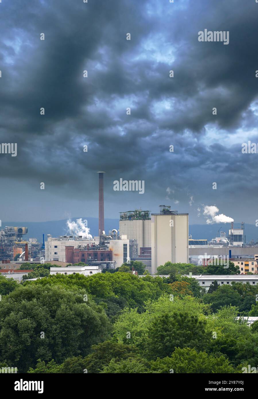Aerial view of large factory with chimneys emitting smoke into the ...
