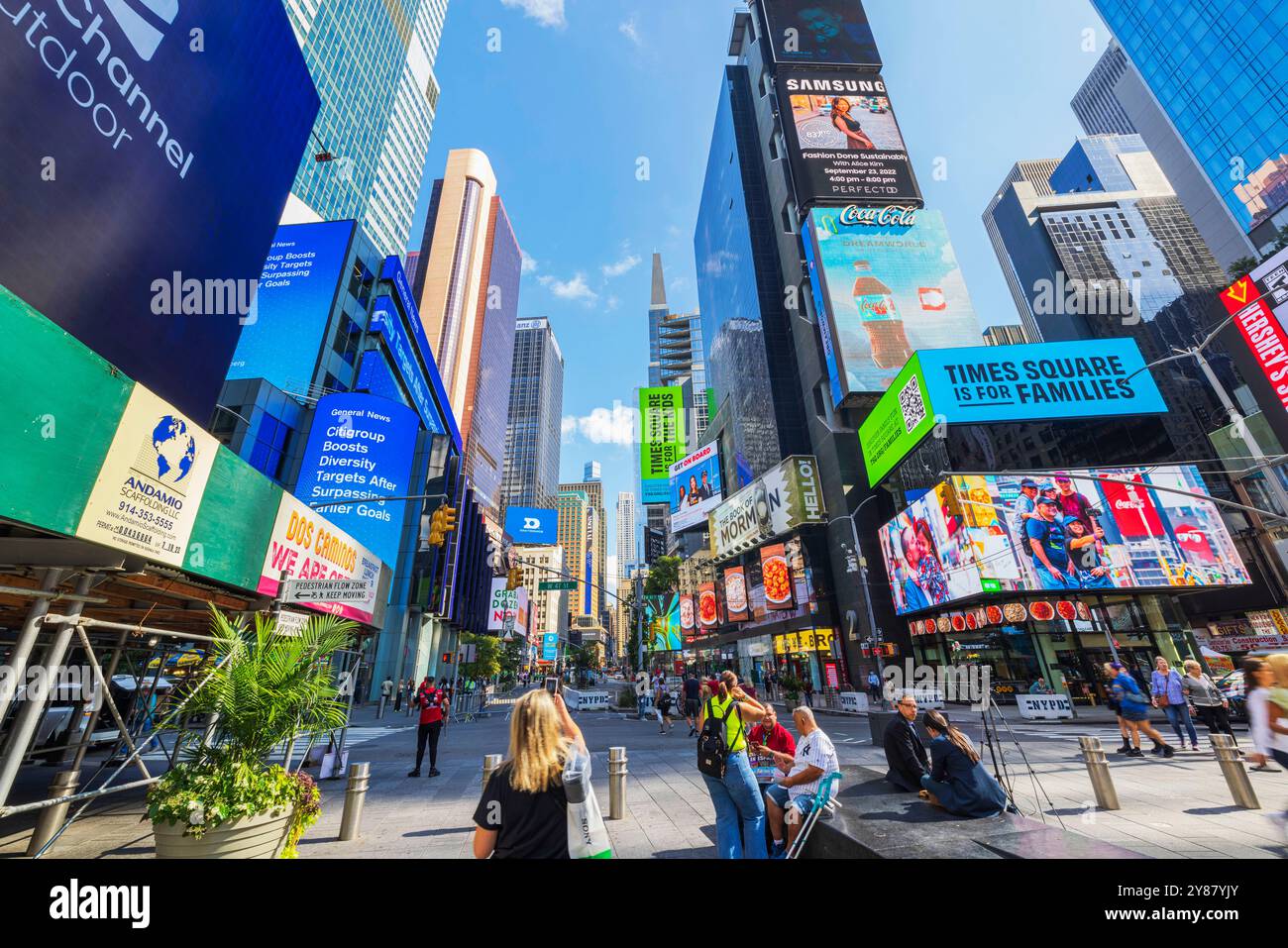 Times Square with bright billboards and people walking on street in New ...