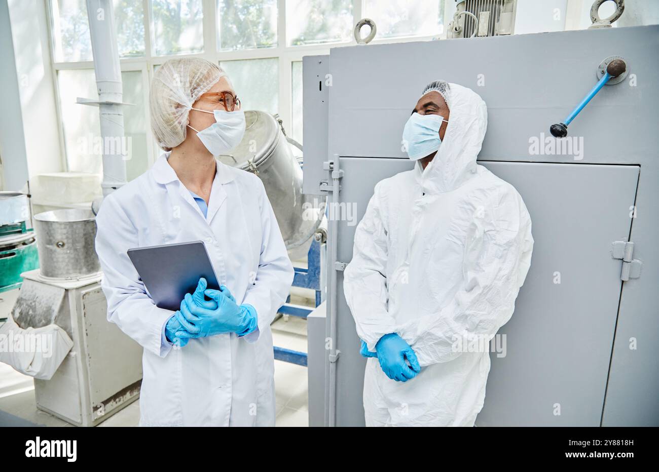 Diverse team of two professional pharmaceutical industry workers in ...