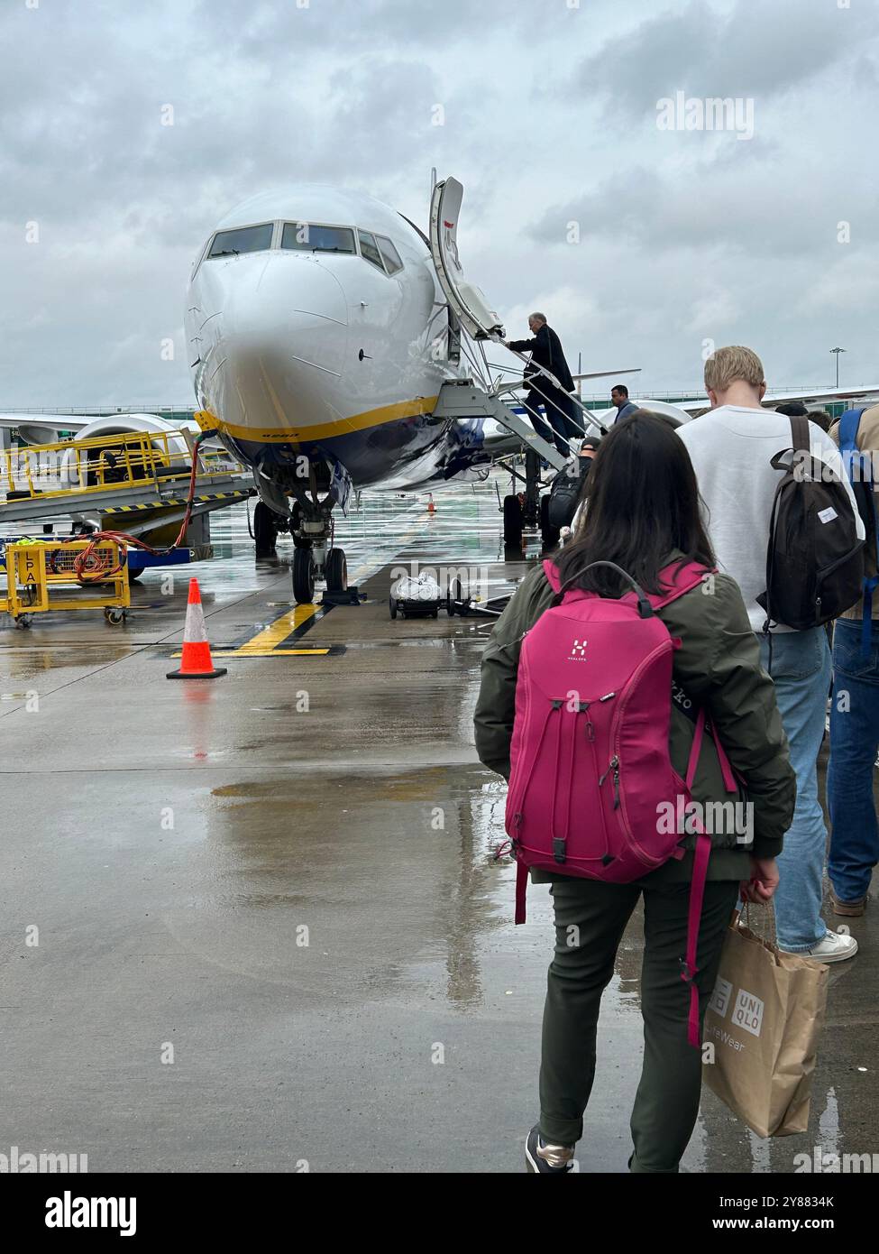 Queueing in the rain for a RyanAir flight at Stanstead Airport, Essex ...
