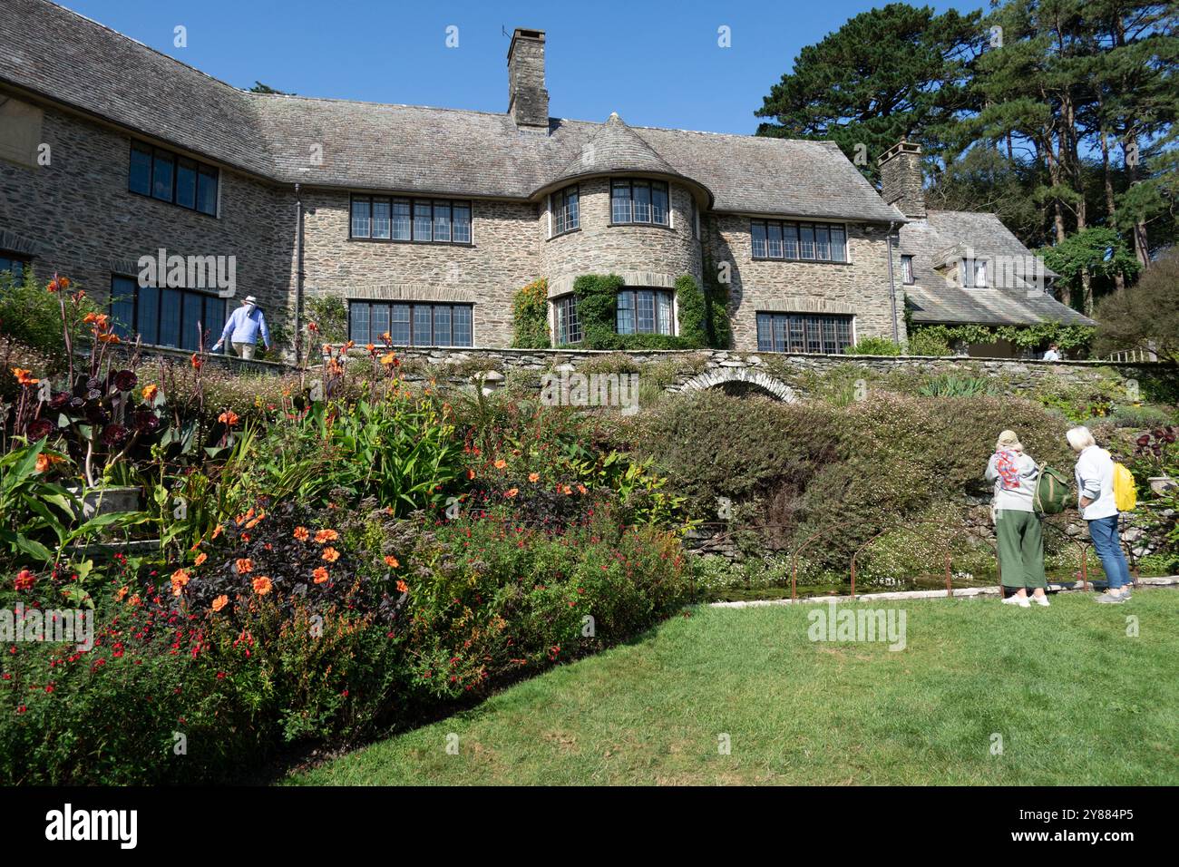 Visitors in gardens in front of house at the national trust property ...